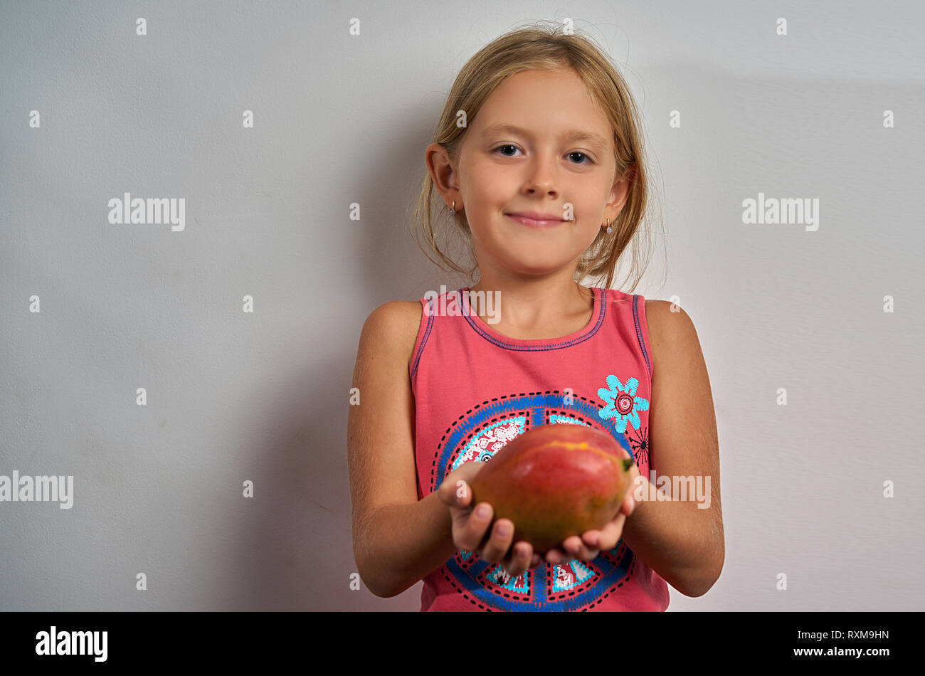 Child eating mango hi-res stock photography and images - Alamy