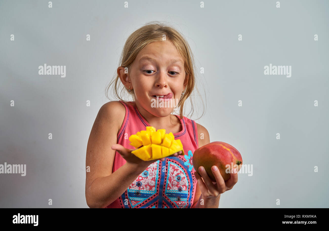 little girl eating mango Stock Photo - Alamy