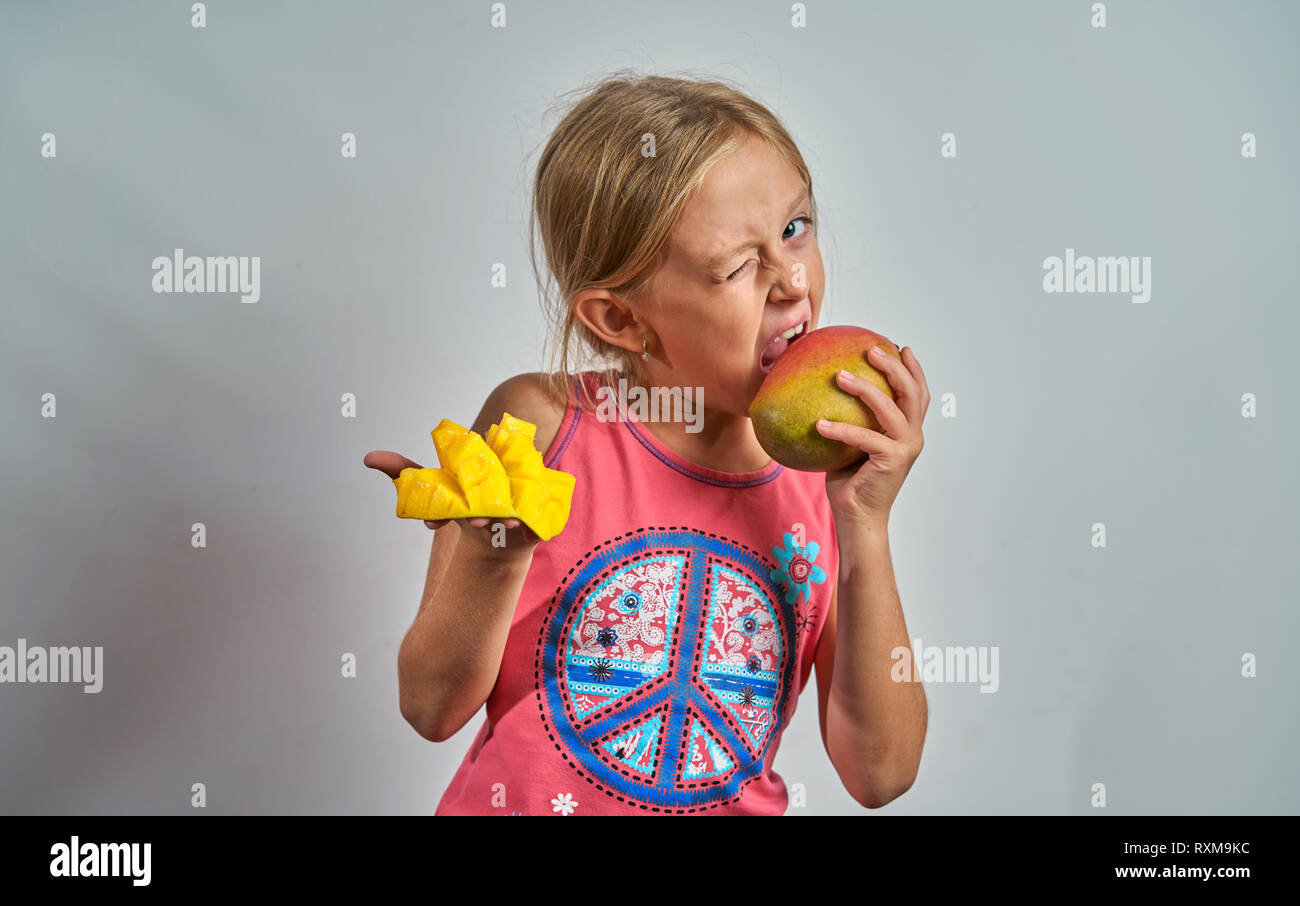 Child holding mango hi-res stock photography and images - Alamy
