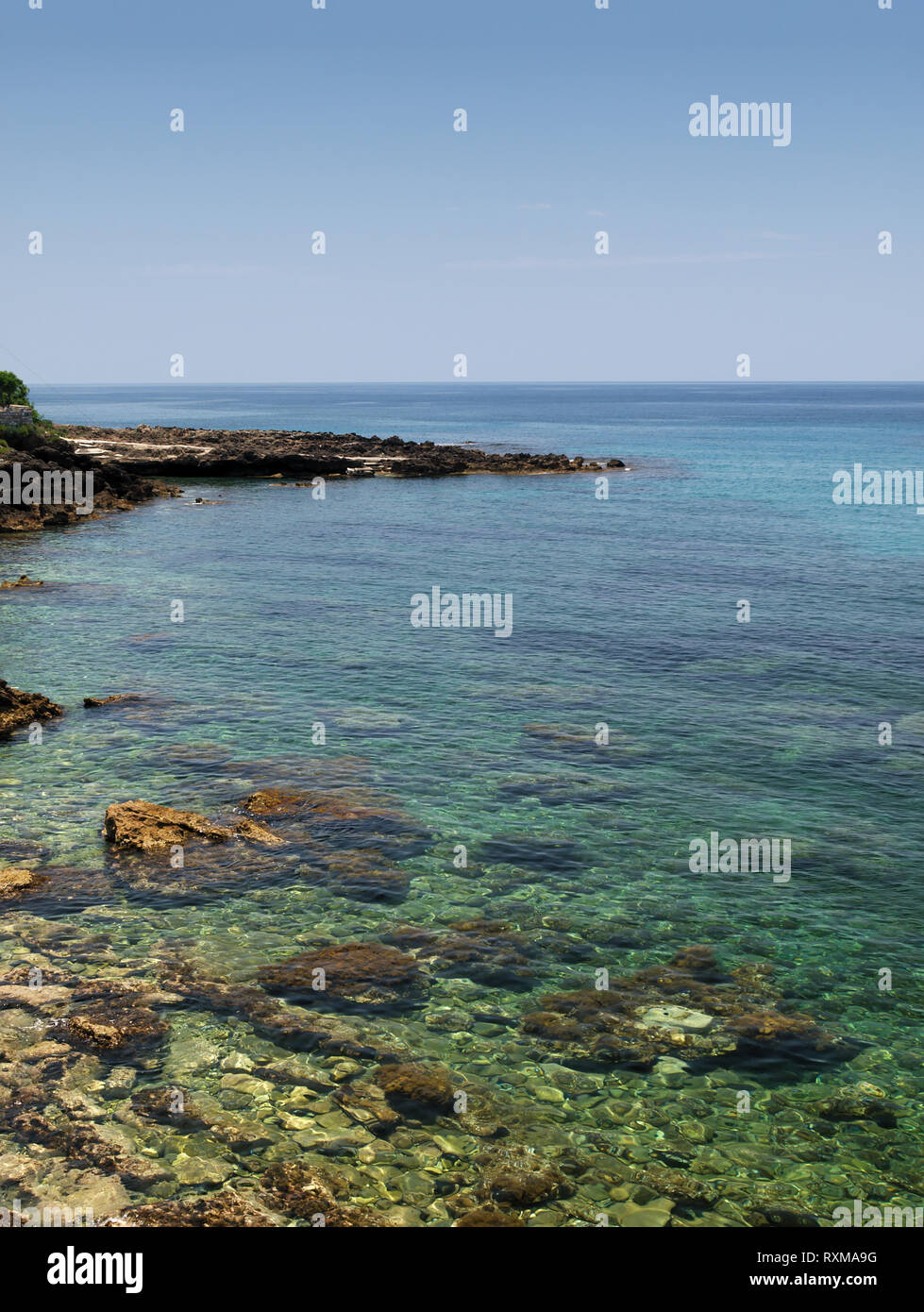 Crystal clear water beach with rocks under day light in Mani, Greece ...