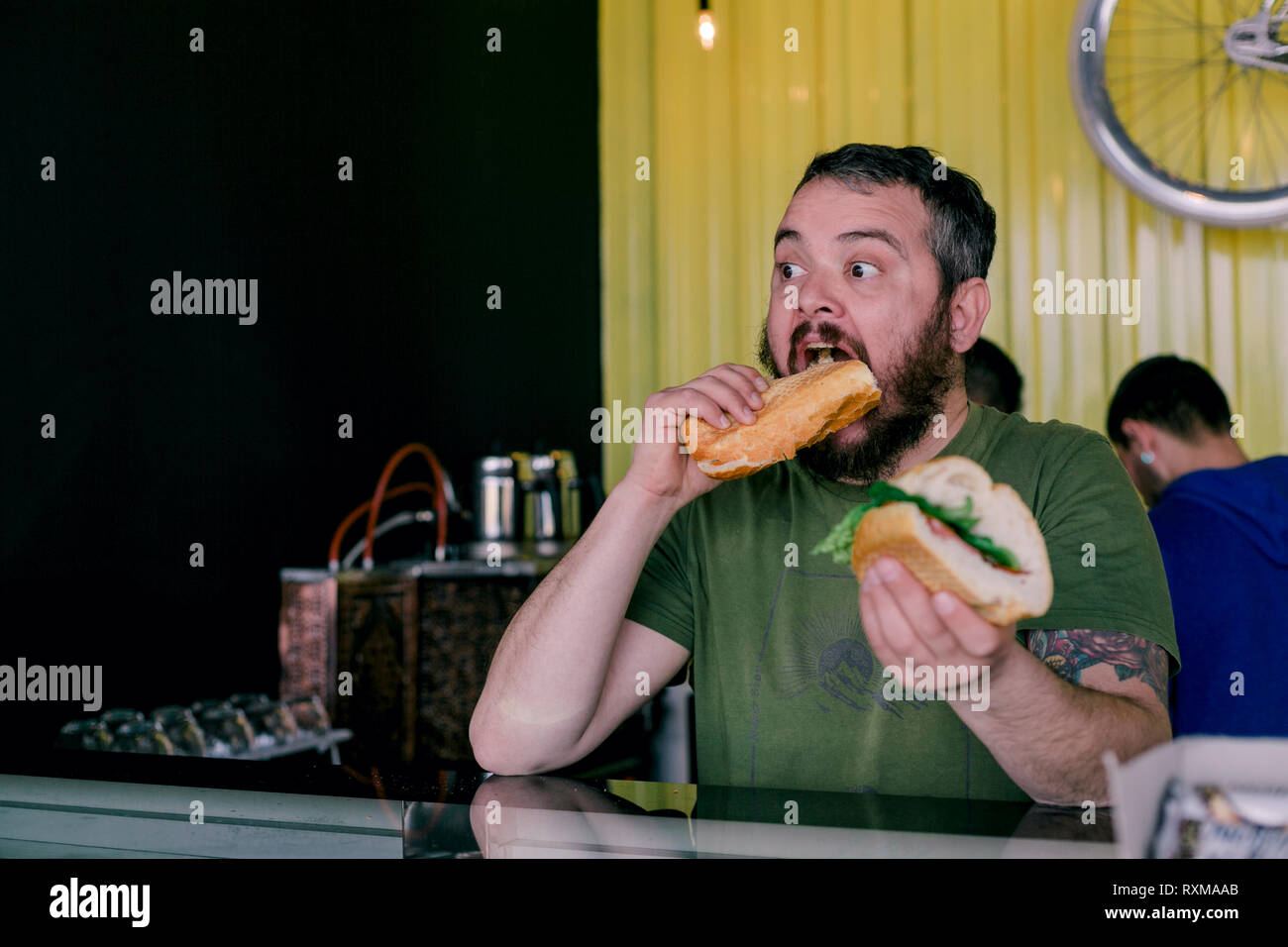 The hungry man who eats a sandwich Stock Photo - Alamy