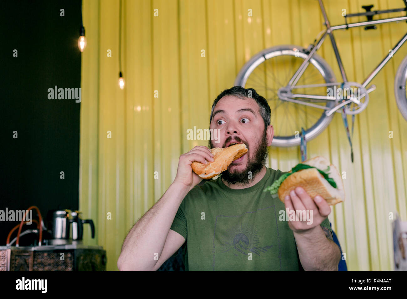The hungry man who eats a sandwich Stock Photo - Alamy