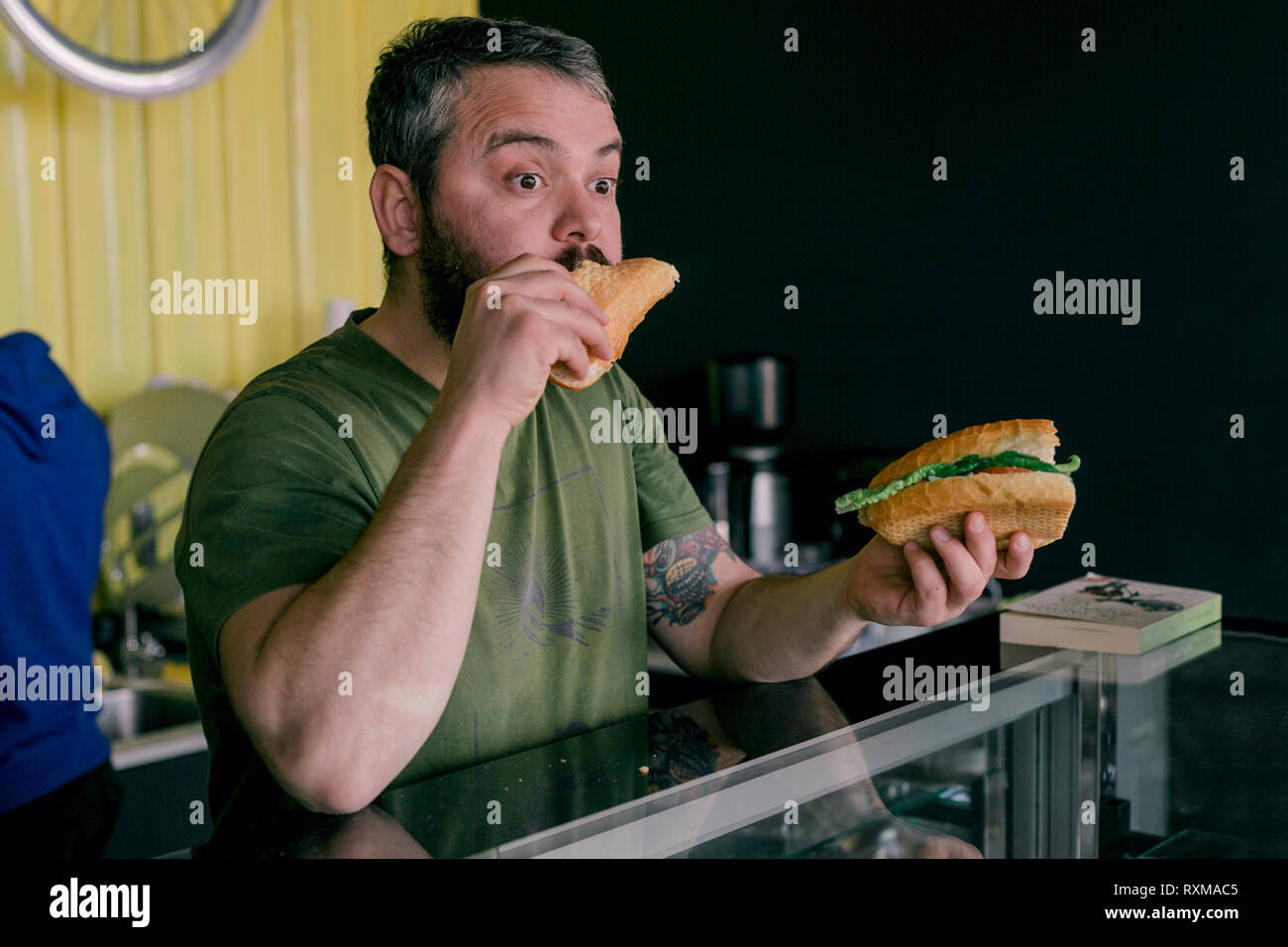 The hungry man who eats a sandwich Stock Photo - Alamy