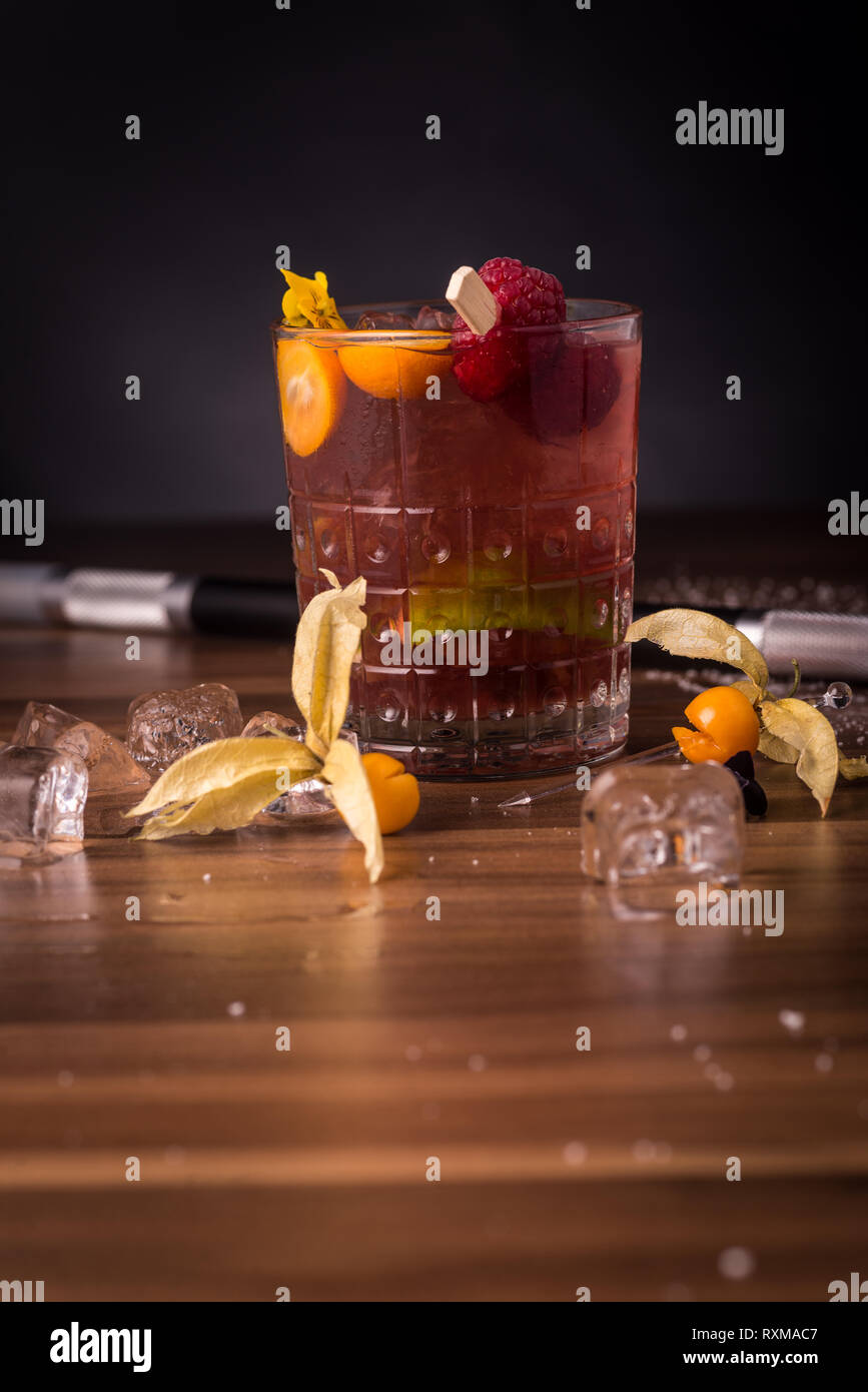Colour Cocktail on dark wooden background Stock Photo - Alamy