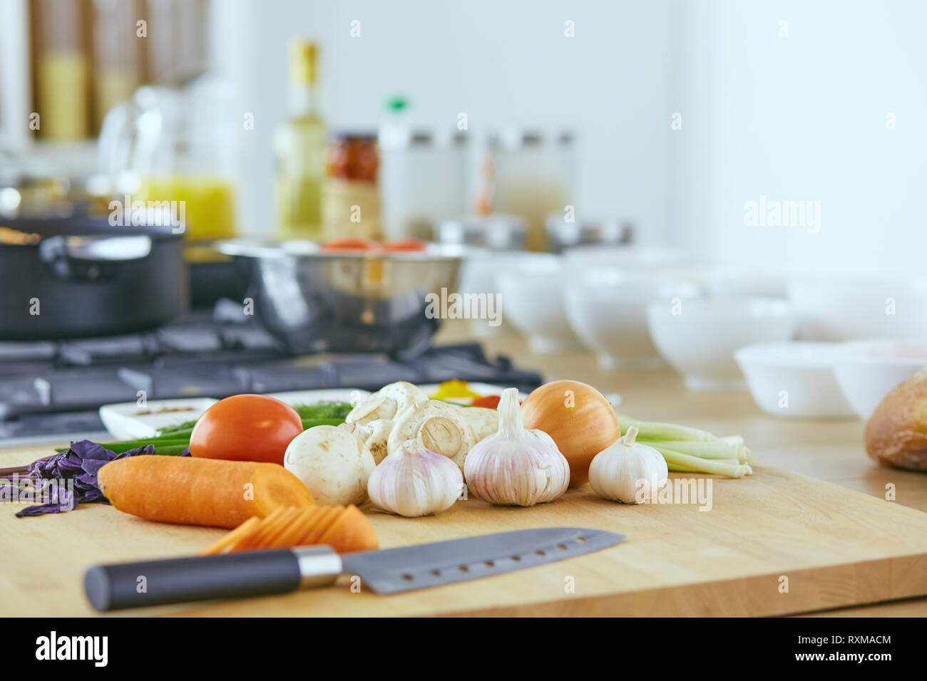 Composition with wooden board and ingredients for cooking on table ...
