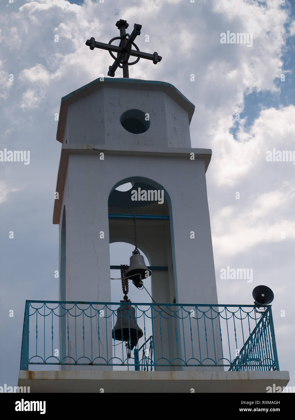 Beautiful white chapel bell tower with metal cross and blue railed ...