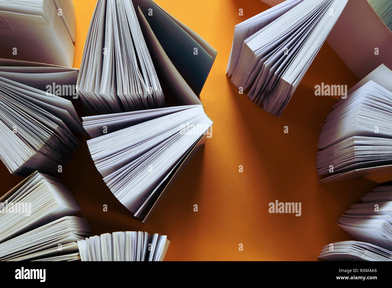 Open books on yellow background Stock Photo - Alamy