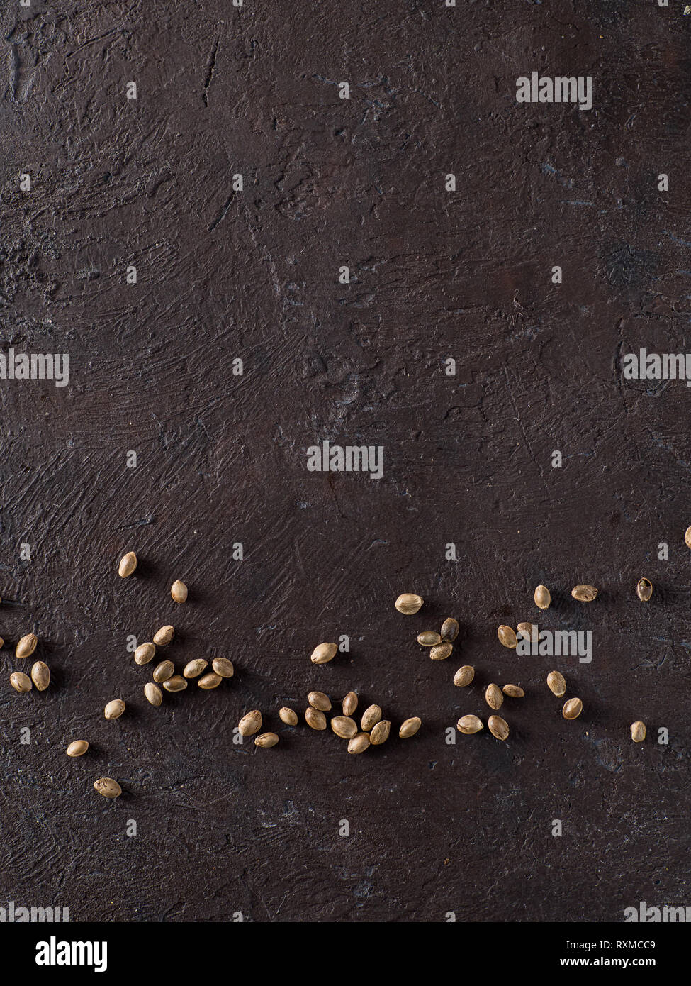 Hemp seeds top view. Unpeeled raw organic hemp seed on black background ...