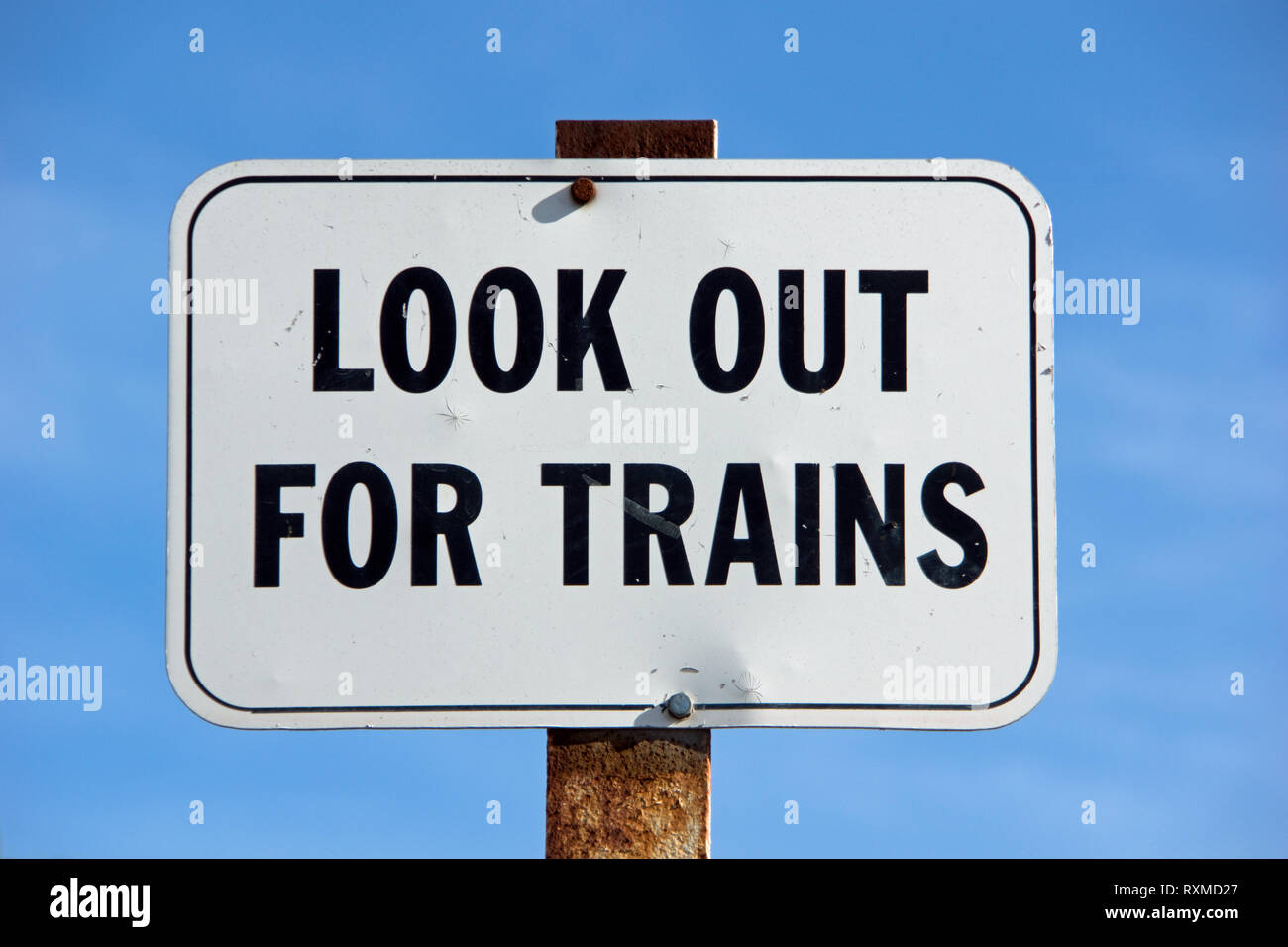 Abstract train warning sign with ‘Look out for trains’ in black ...