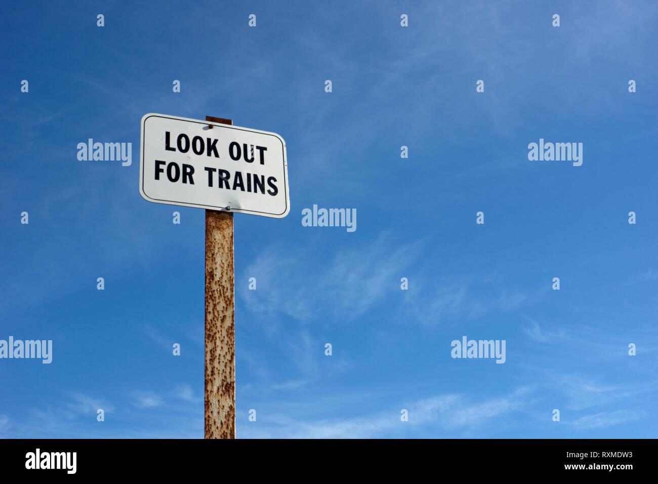 Abstract train warning sign with ‘Look out for trains’ in black ...