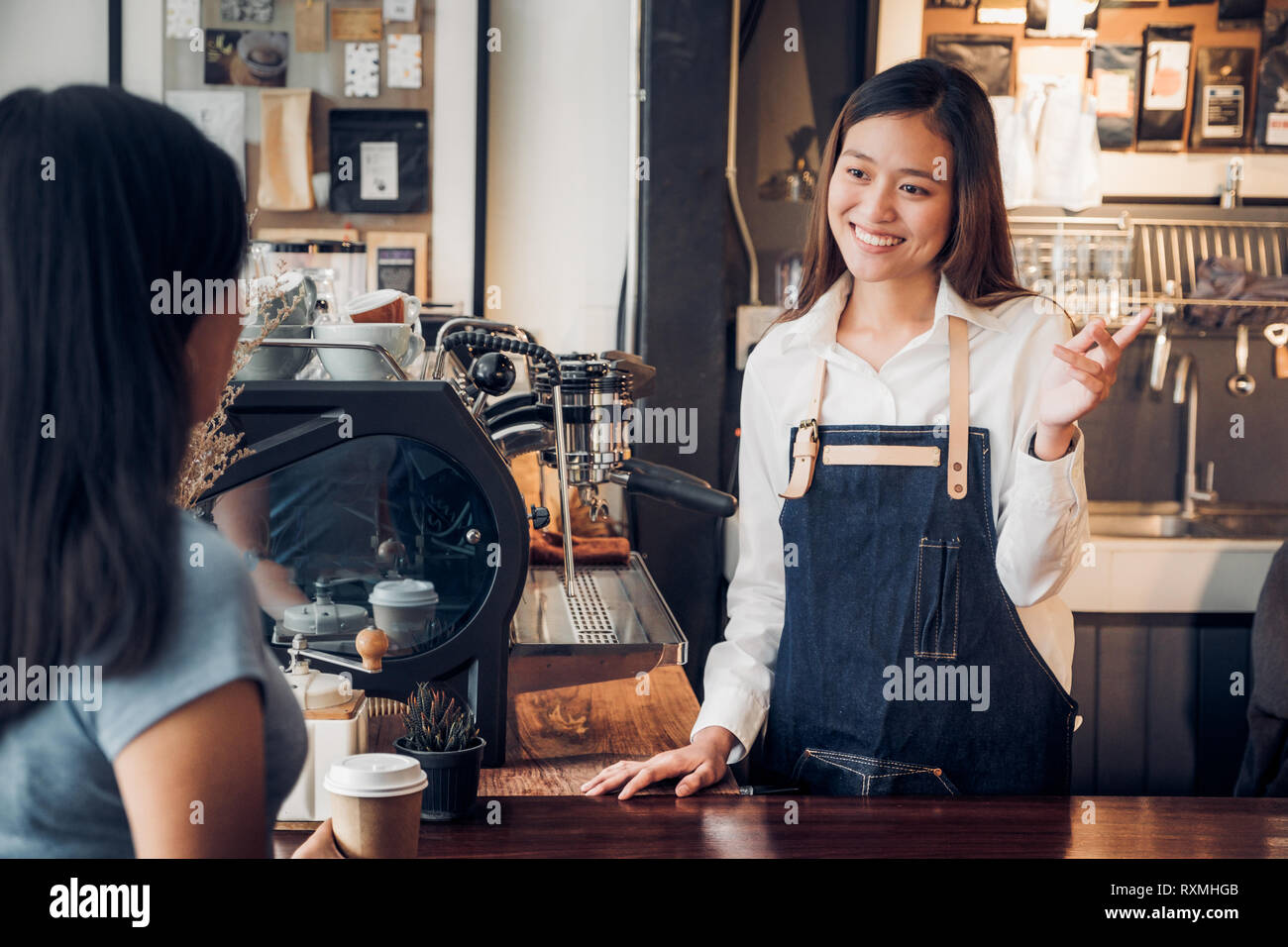 Happy barista talking customer coffee hi-res stock photography and ...