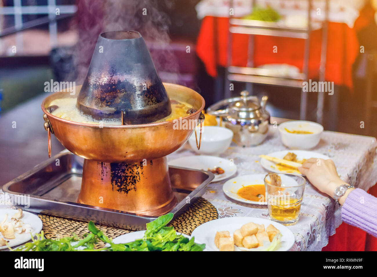Asian traditional double hot pot close-up with lettuce leaves Stock ...