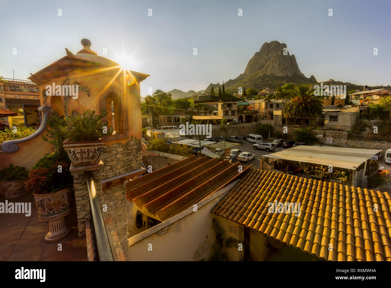 The sun descending over the town of Bernal and the Peña de Bernal ...
