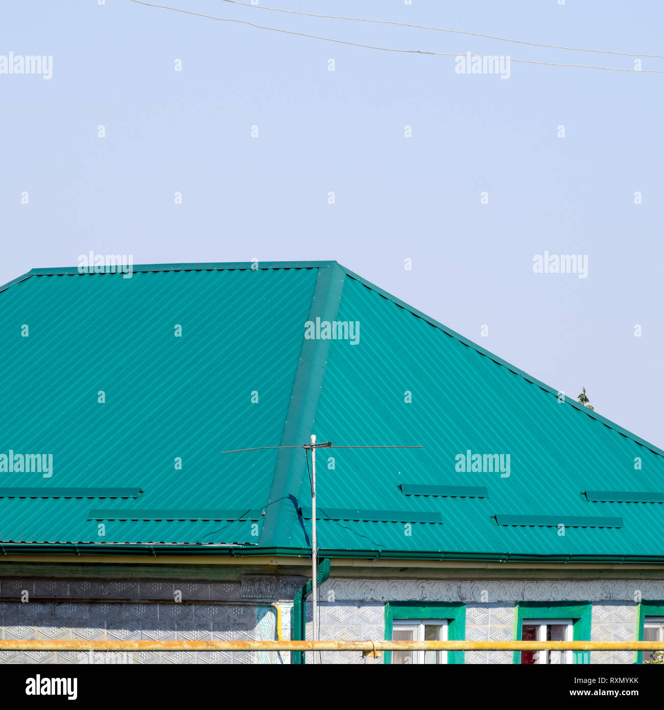 Green metal profile corrugated roofing on the house Stock Photo - Alamy