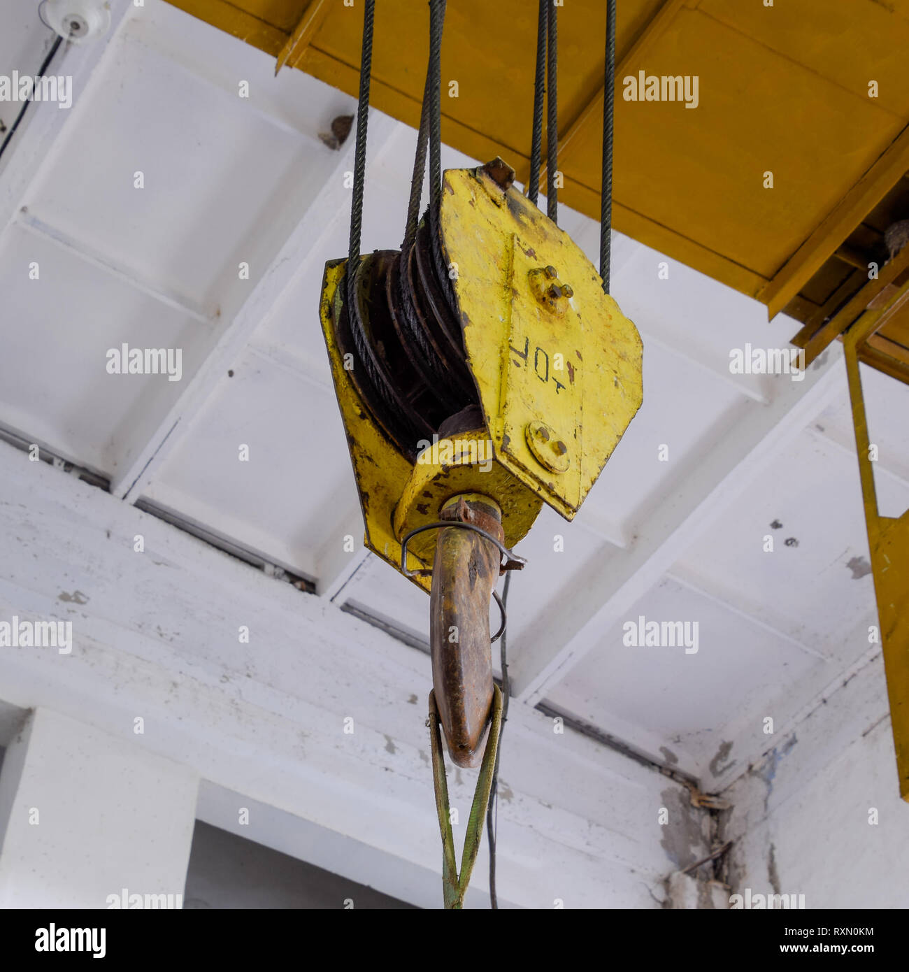 Hoist with winch and hook. A tool for moving goods in a production room ...