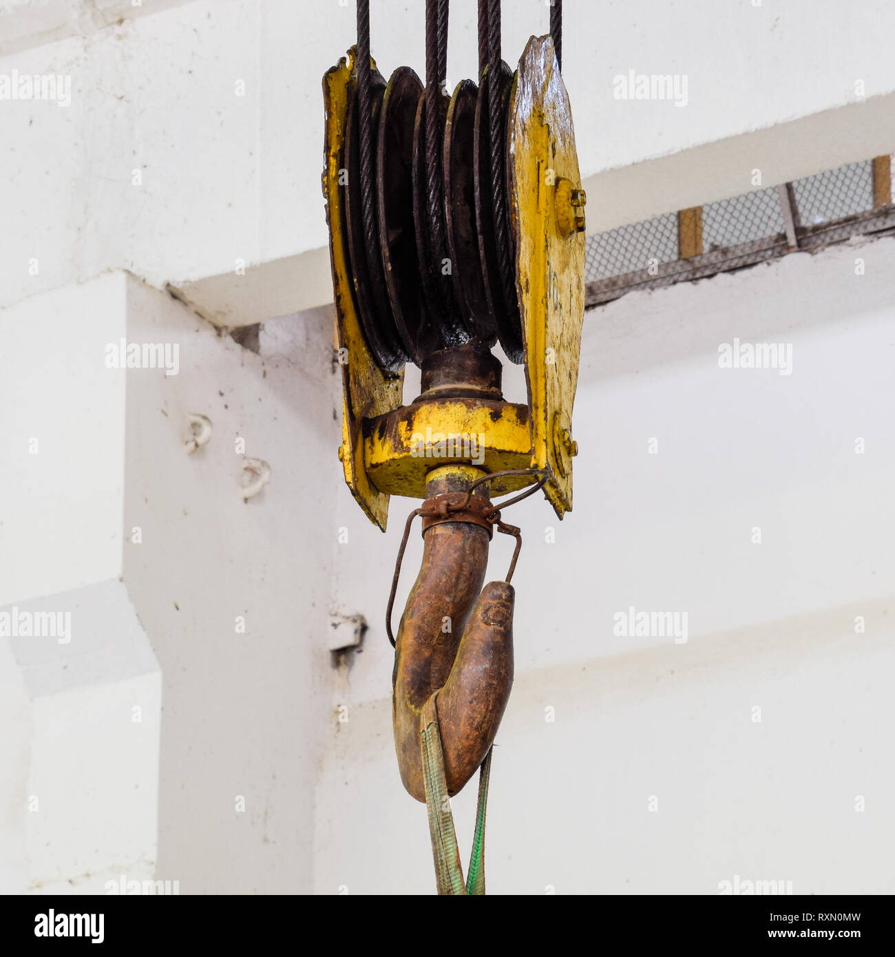 Hoist with winch and hook. A tool for moving goods in a production room ...