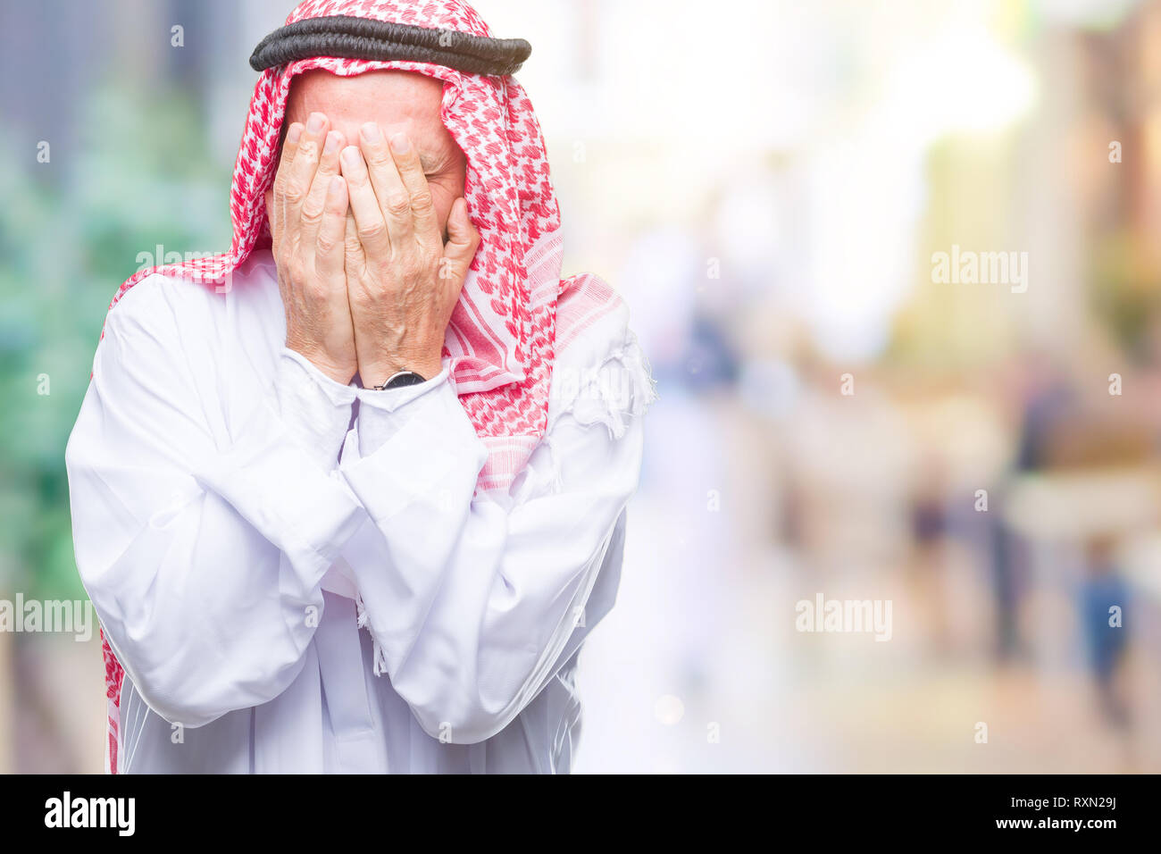 Senior arab man wearing keffiyeh over isolated background with sad ...