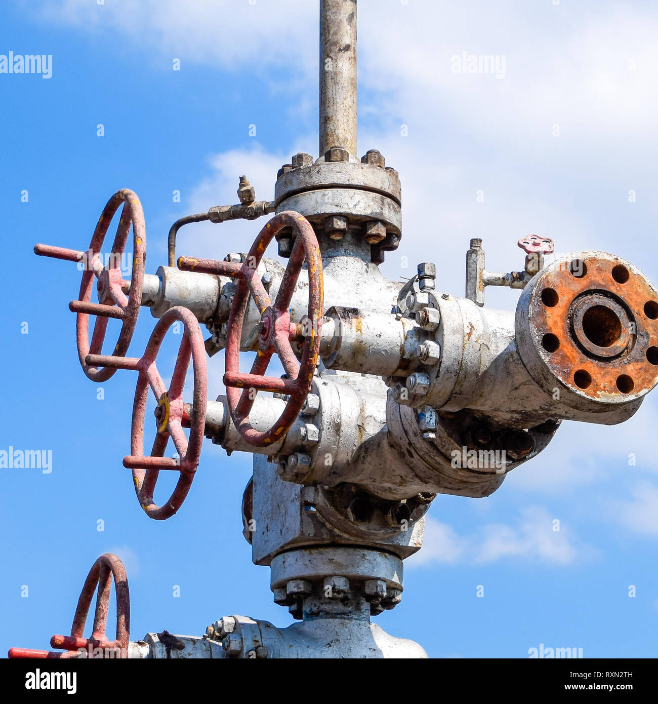 Oil well after repair in mud and puddles. Oil well wellhead equipment ...