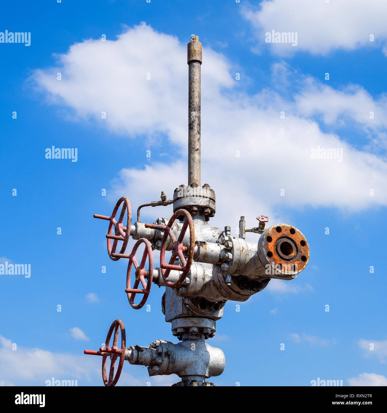 Oil well after repair in mud and puddles. Oil well wellhead equipment ...