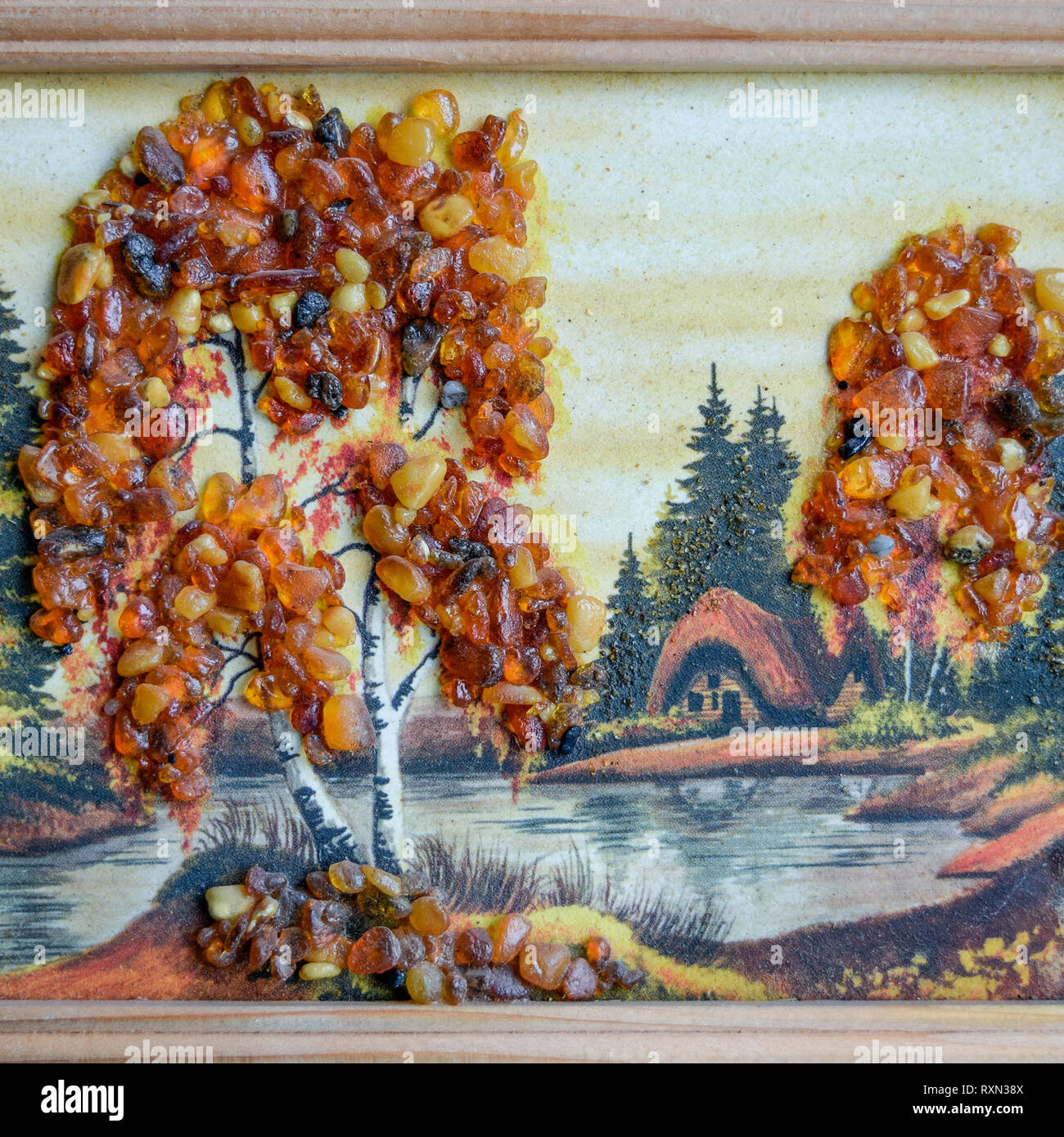 Picture of an amber stone. Crafts made of amber. Landscape house by the ...