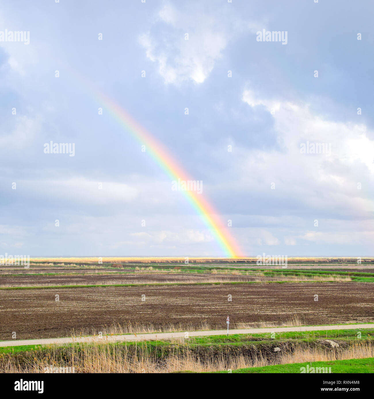 Rainbow, a view of the landscape in the field. Formation of the rainbow ...