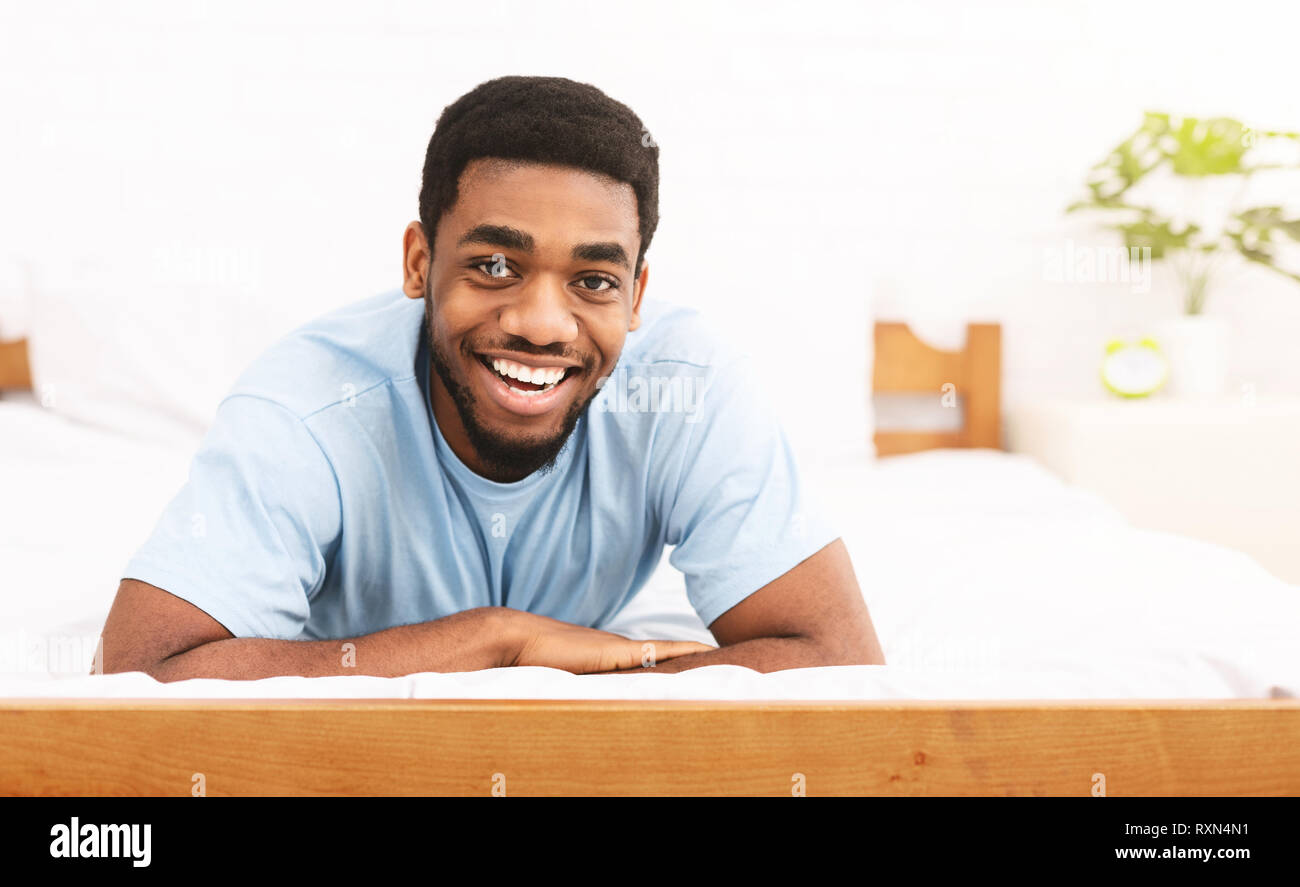 Black man lying on bed hi-res stock photography and images - Alamy