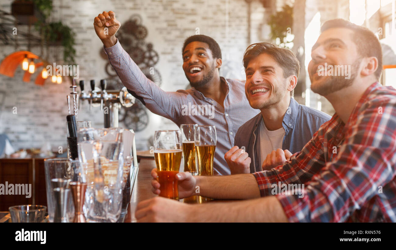 Football fans drinking beer, celebrating victory at bar Stock Photo - Alamy