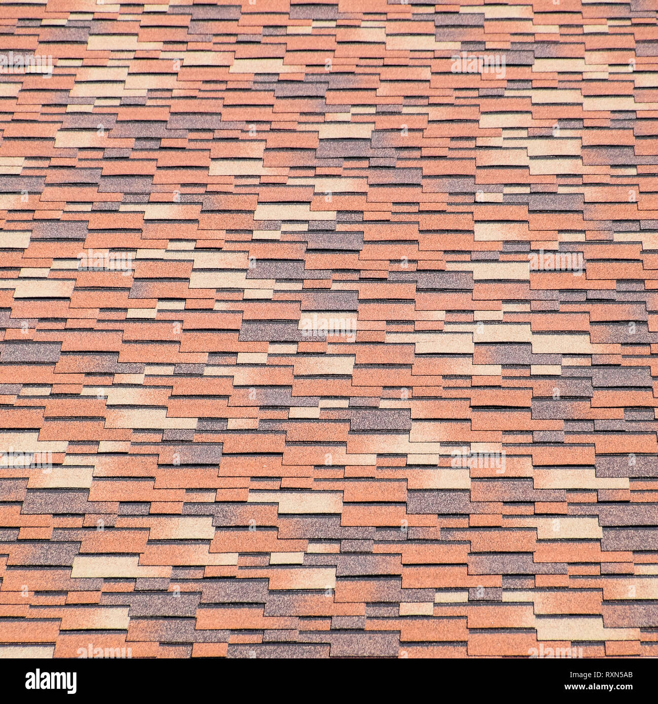 Roof from multi-colored bituminous shingles. Patterned bitumen shingles ...