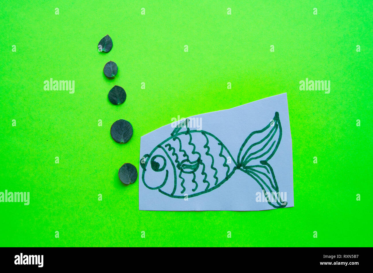 Funny fish with bubbles on green background, fool's Day Stock Photo - Alamy