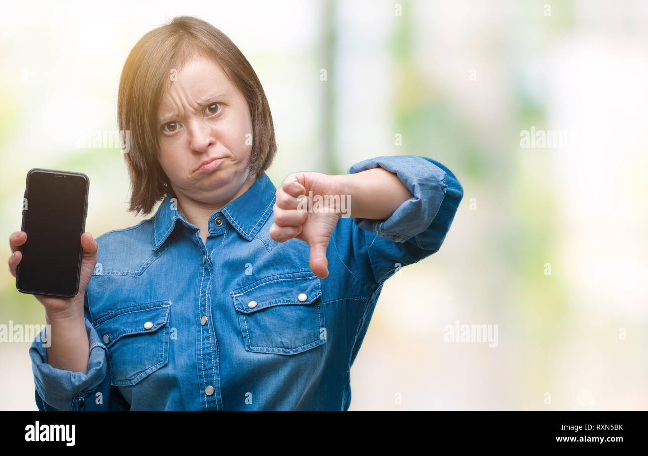 Young adult woman with down syndrome showing smartphone screen over ...