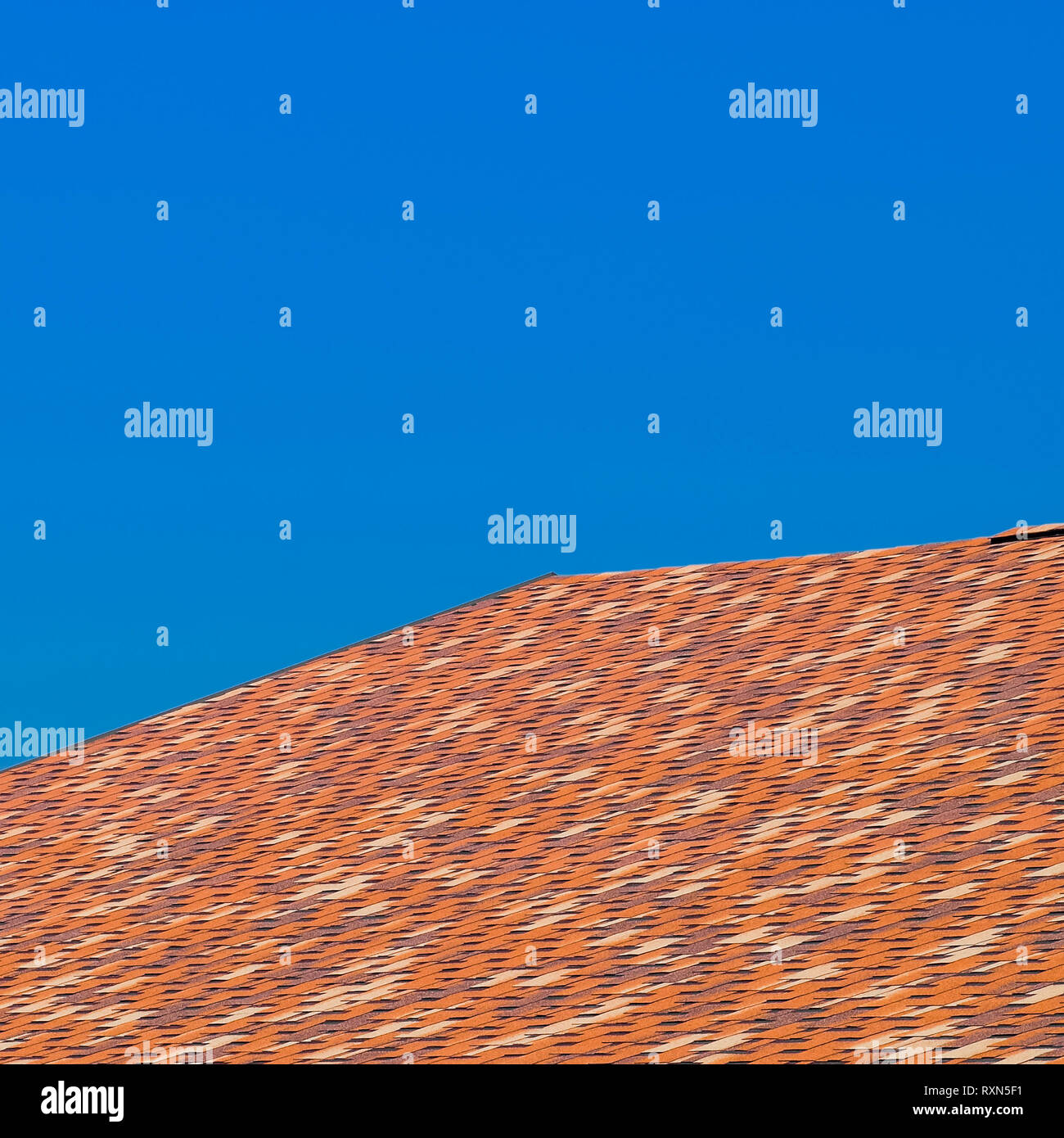 Roof from multi-colored bituminous shingles. Patterned bitumen shingles ...