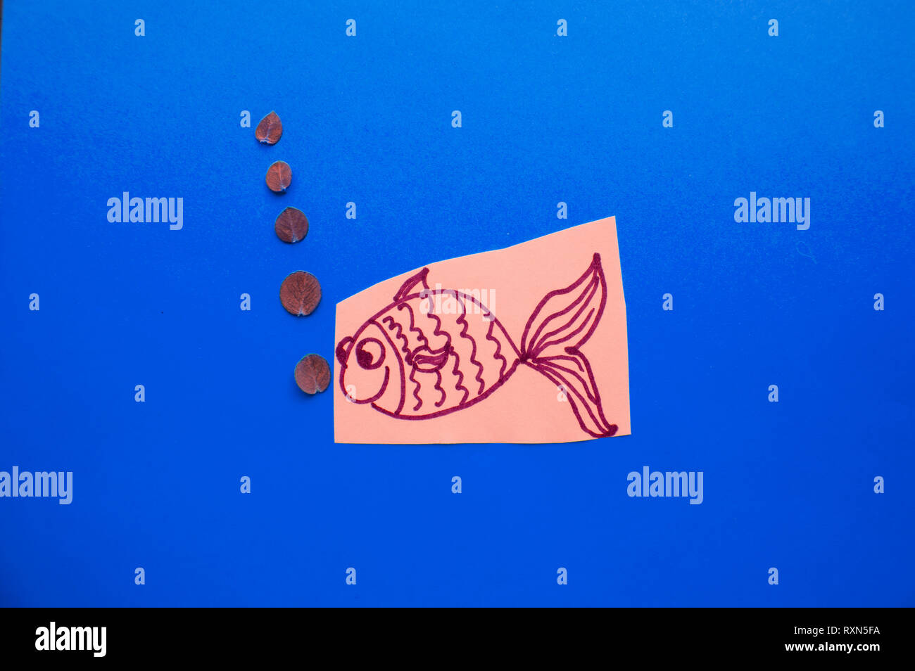 Funny fish with bubbles on blue background, fool's Day Stock Photo - Alamy