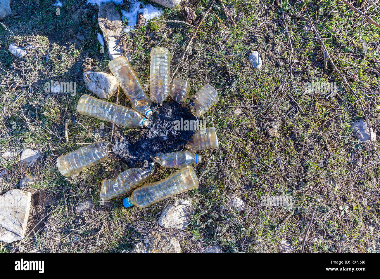 Burnt plastic bottles on grass Stock Photo - Alamy