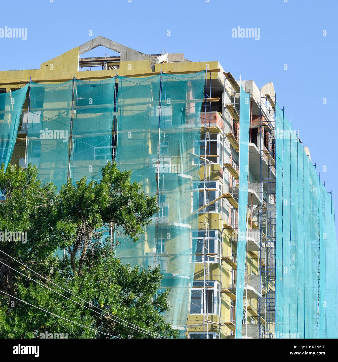 Safety net in the newly built high-rise building. Green grid on ...