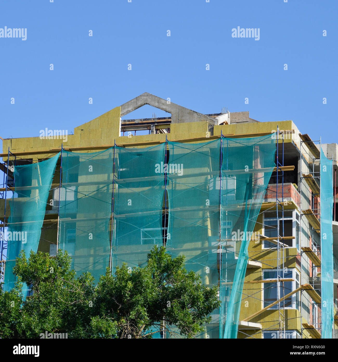 Safety net in the newly built high-rise building. Green grid on ...