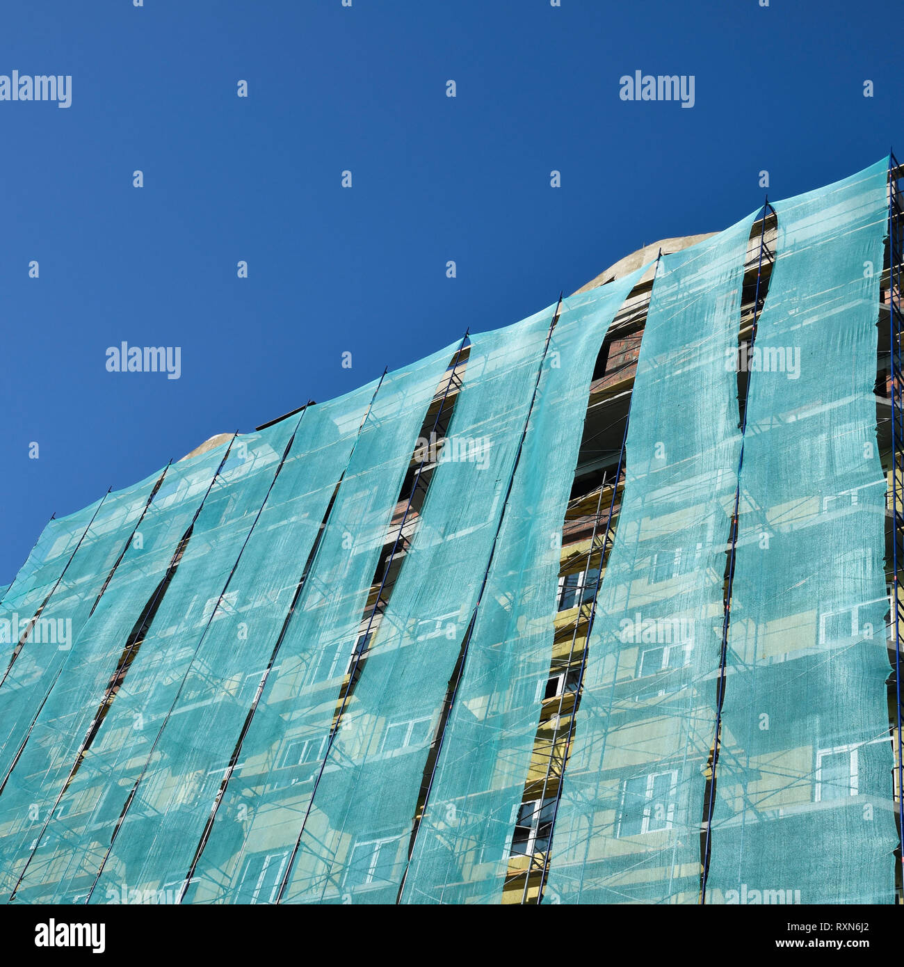 Safety net in the newly built high-rise building. Green grid on ...