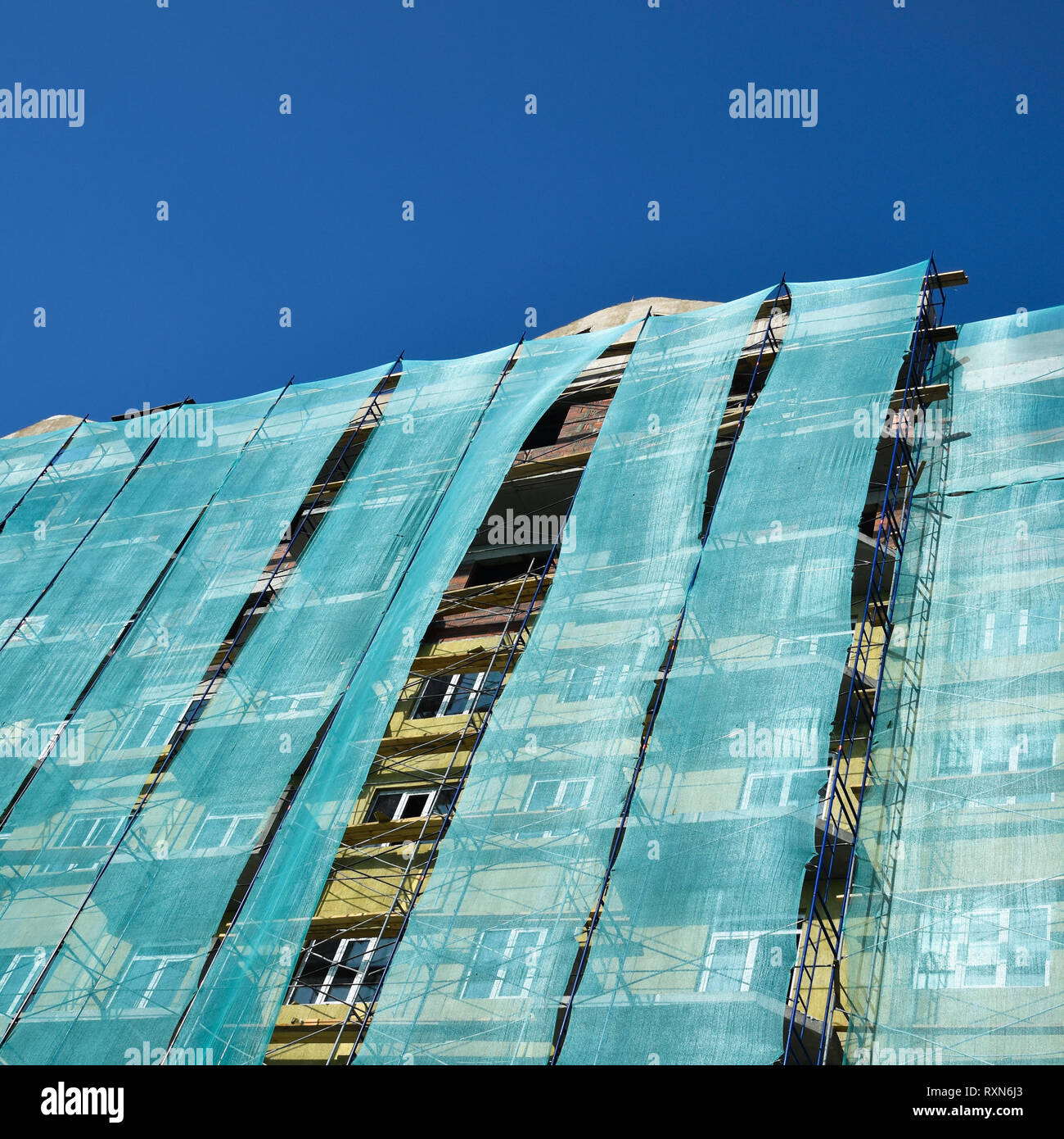Safety net in the newly built high-rise building. Green grid on ...