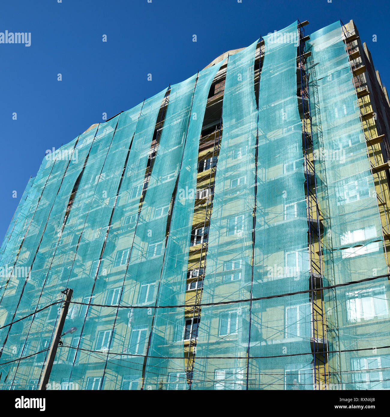 Safety net in the newly built high-rise building. Green grid on ...