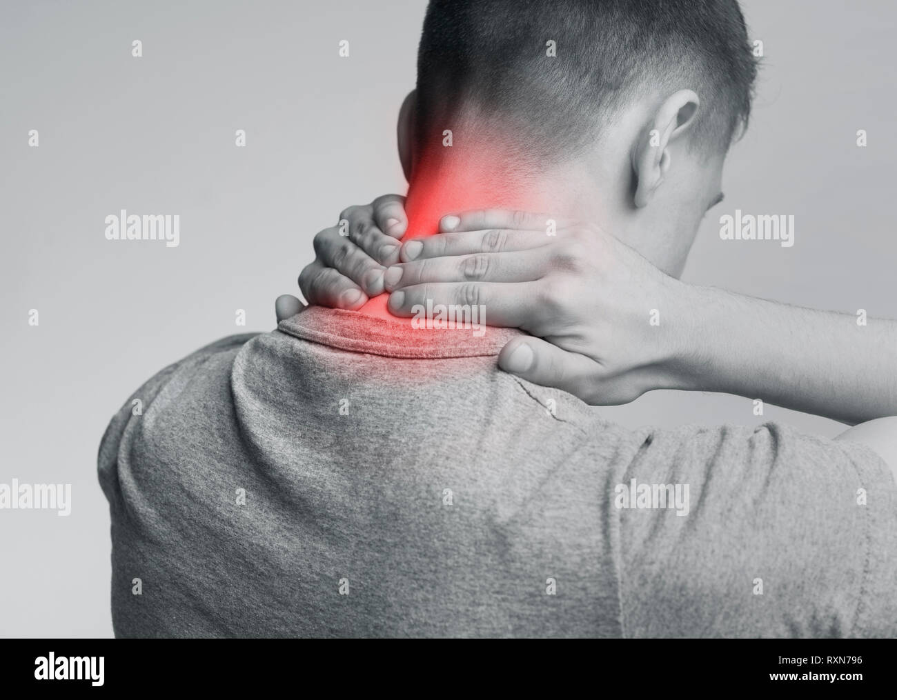 Strong man with neck pain, back view Stock Photo - Alamy