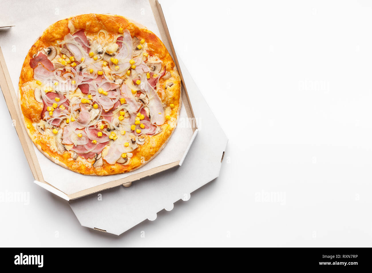 Pizza in delivery box on white table Stock Photo - Alamy