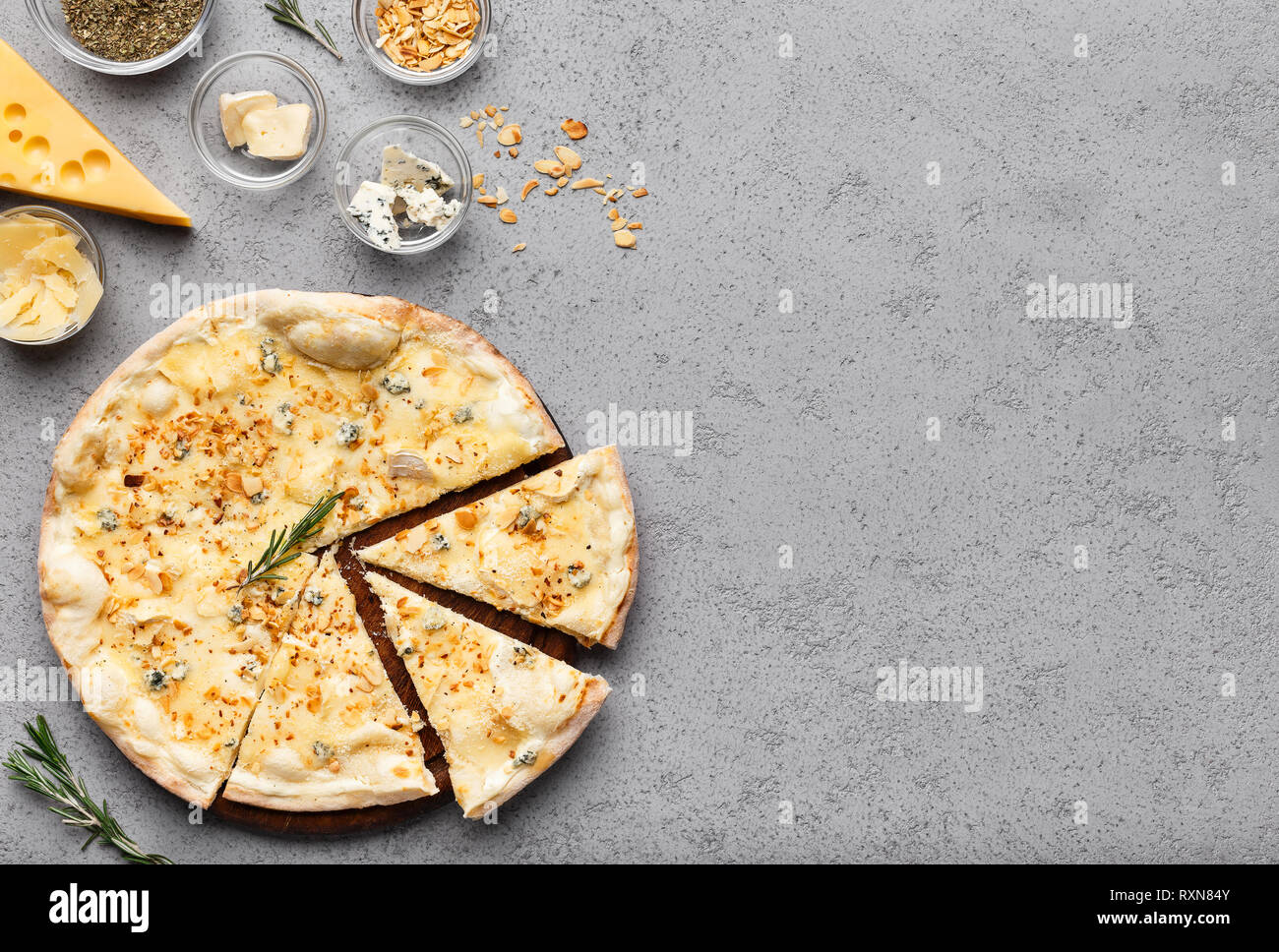 Pizza quattro fromaggi cutted into slices, top view Stock Photo - Alamy