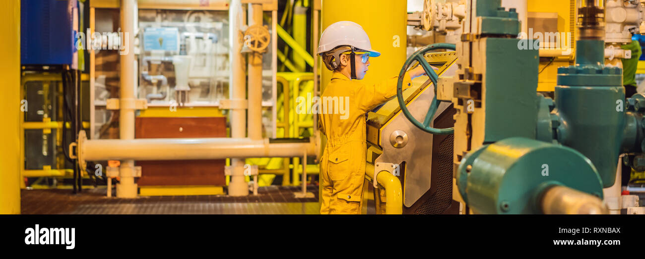 Boy operator recording operation of oil and gas process at oil and rig ...