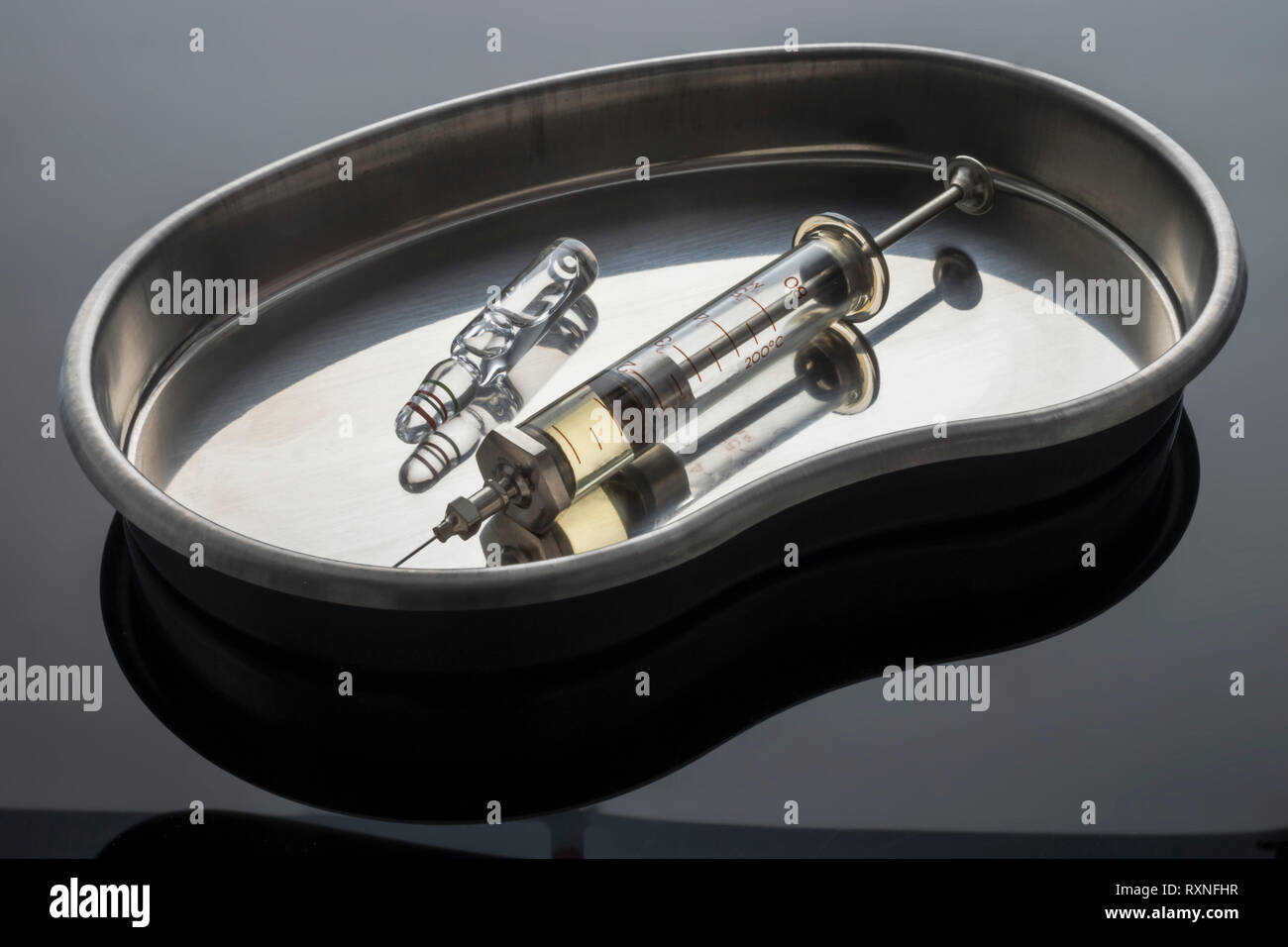 Syringe loaded with medication next to medicine vial prepared in ...