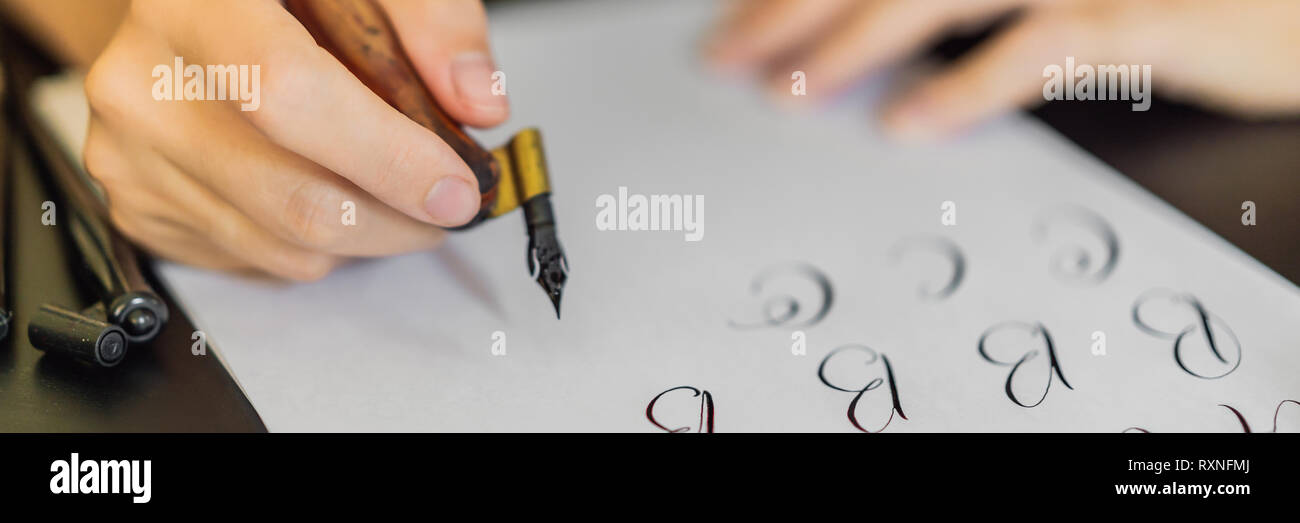 Calligrapher hands writes phrase on white paper. Inscribing ornamental ...