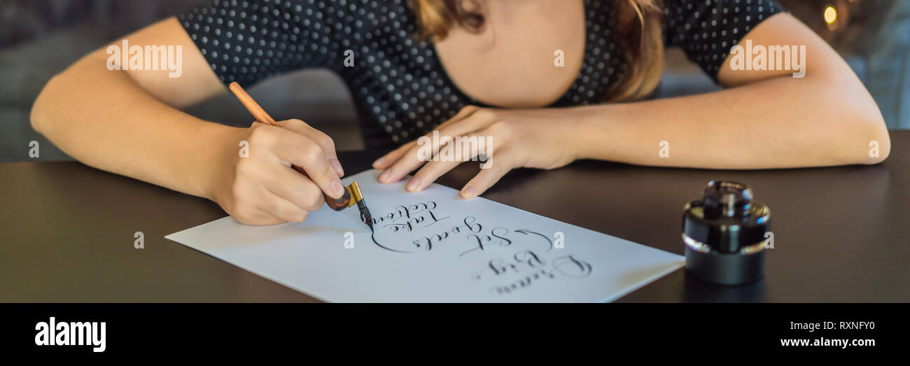 Calligrapher Young Woman writes phrase on white paper. Dream big, set ...