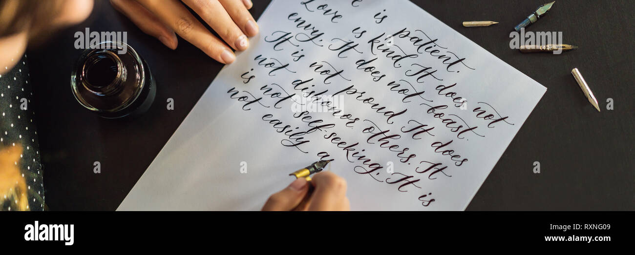 Calligrapher hands writes phrase on white paper. Bible phrase about ...