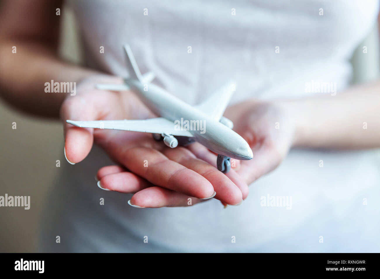 Female woman hands holding small toy model plane. Travel by plane ...