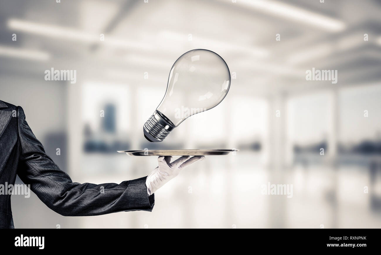 Hand of waitress presenting lightbulb on tray Stock Photo - Alamy