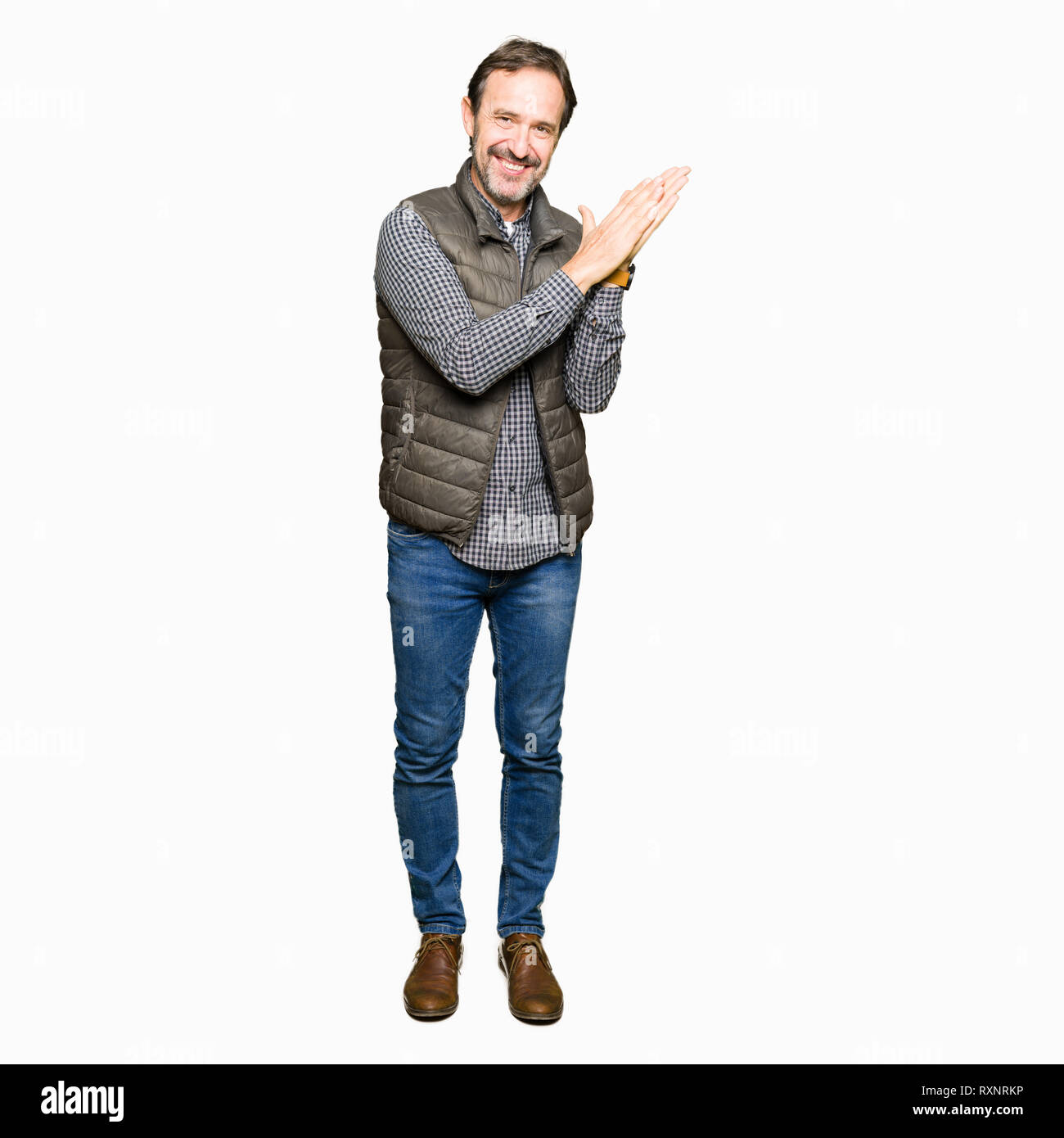Middle age handsome man wearing winter vest Clapping and applauding ...