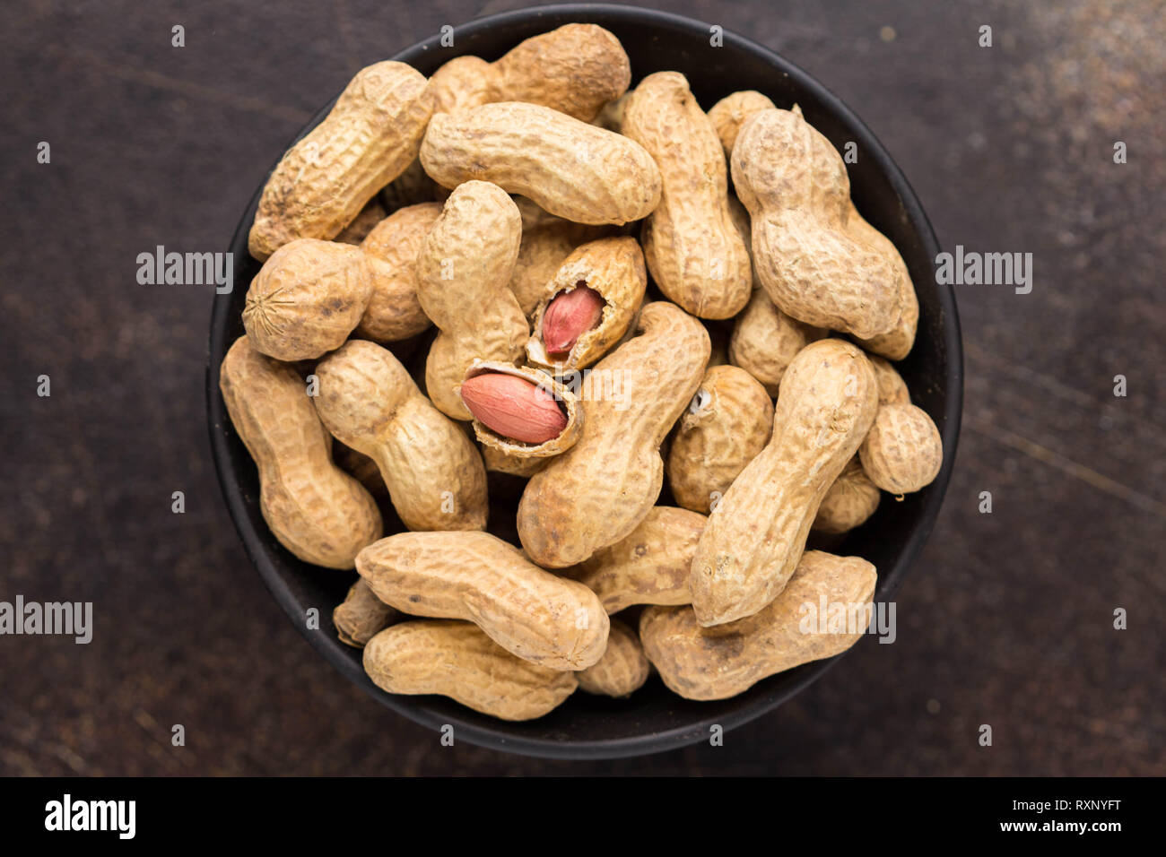 Peanuts in shell in bowl on dark background. Healthy food, whole ...